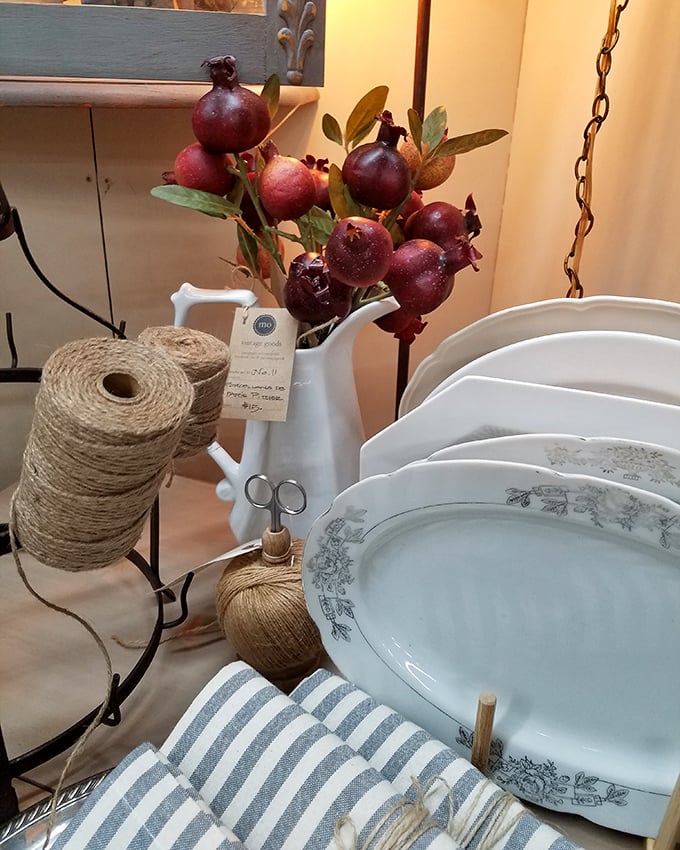 Farmhouse chic in its natural habitat. That white pitcher filled with pomegranates transforms ordinary tableware into a still life painting.