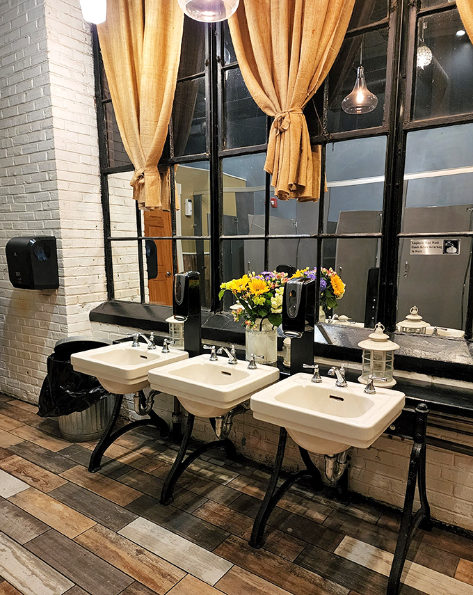 Even the restroom maintains the rustic-chic aesthetic&mdash;vintage sinks and burlap curtains prove attention to detail extends beyond the kitchen.
