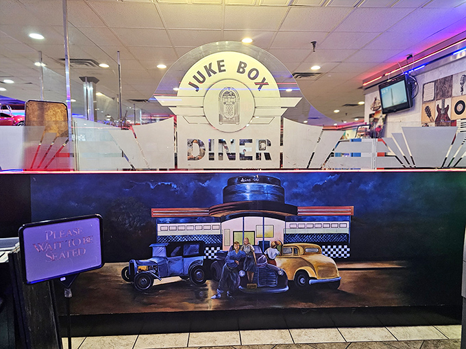 The mural depicting vintage cars at an old-school diner creates a story-within-a-story effect. Meta nostalgia at its finest.