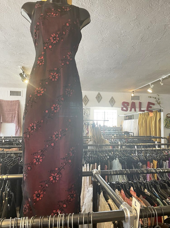Elegant embroidered dress catches sunlight through the windows. This burgundy showstopper with floral details costs less than dinner for two at a fancy restaurant.