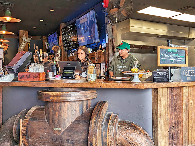 The register area, where money changes hands and barbecue dreams come true. That wooden barrel counter has absorbed enough barbecue stories to write a novel.