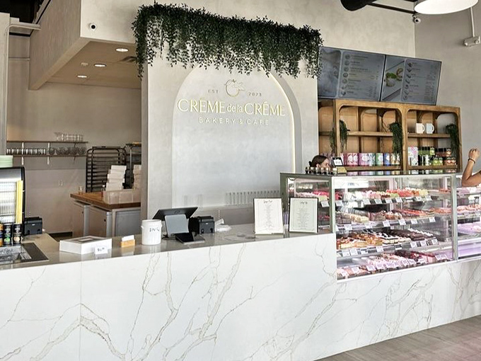 Marble countertops and hanging greenery create a welcoming first impression. The café's elegant design makes ordering feel like the start of an experience.