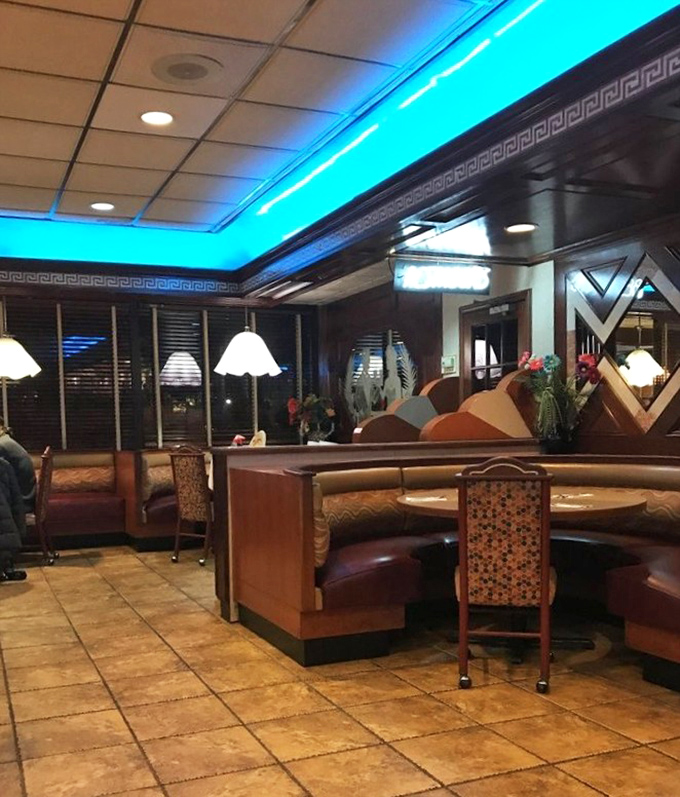 Blue lighting transforms ordinary dining into something special. These booths have heard every "How was your day?" since Reagan was president.