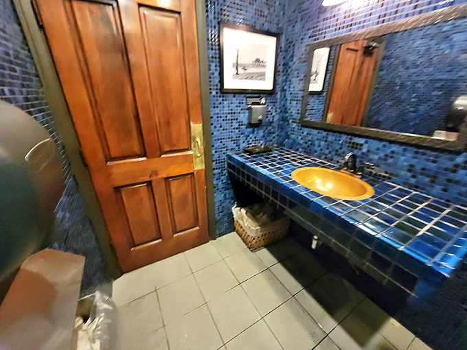 Even the restroom gets the full treatment&mdash;blue tile mosaic and warm wood that says, "Yes, we care about every single detail in this place."