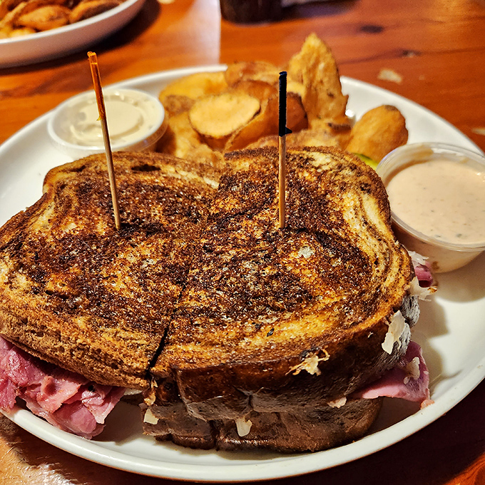 This Reuben sandwich isn't messing around &ndash; it's a skyscraper of corned beef and sauerkraut that demands respect and extra napkins.