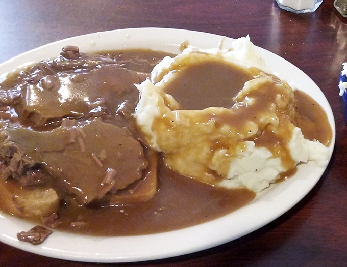 A hot roast beef sandwich that doesn't just sit on the plate&mdash;it commands respect with gravy cascading over the sides like a delicious waterfall.