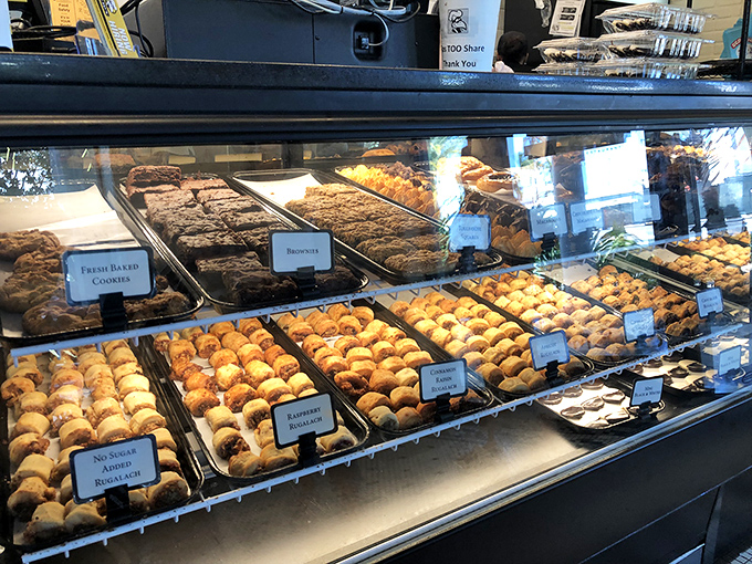 The bakery case showcases rugelach and cookies that would make your grandmother simultaneously proud and jealous of their perfect execution.