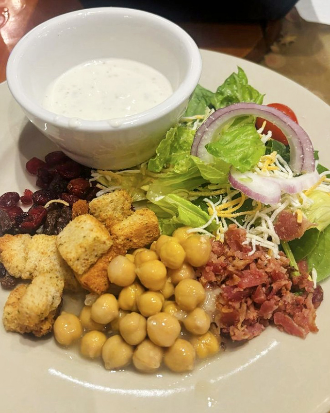 A salad that actually deserves attention. Crisp greens, chickpeas, and bacon bits create the rare side dish that isn't just an obligation.