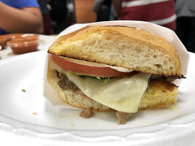 Even the torta gets the royal treatment here. This isn't just a sandwich; it's a carefully constructed monument to the art of proper ingredient layering.