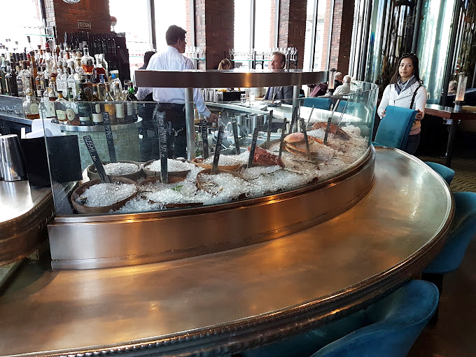 The raw bar display is seafood theater in the round&mdash;oysters lounging on ice like celebrities sunbathing on private beaches.
