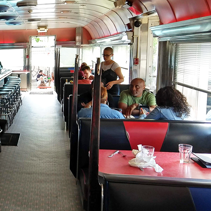The classic diner layout creates intimate dining pods where strangers become friends over plates of comfort food and bottomless coffee.