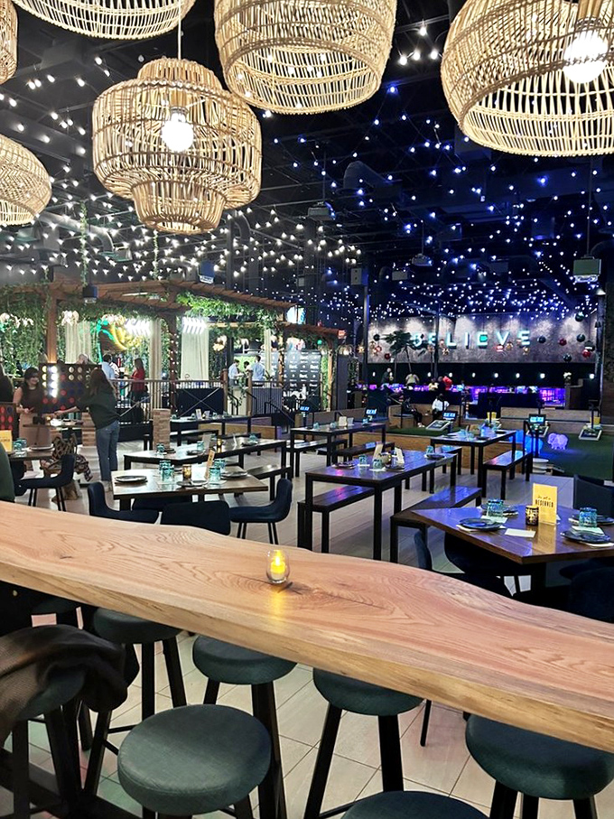 Dining under a constellation of lights and woven pendants. The thoughtful design creates intimate spaces within the vast playground for grown-ups.