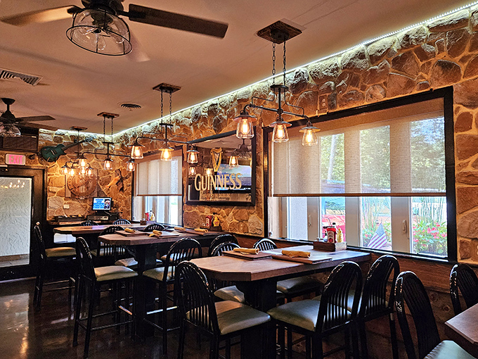 Warm lighting, stone walls, and wood accents create the dining room equivalent of a bear hug. Guinness sign optional but appreciated.
