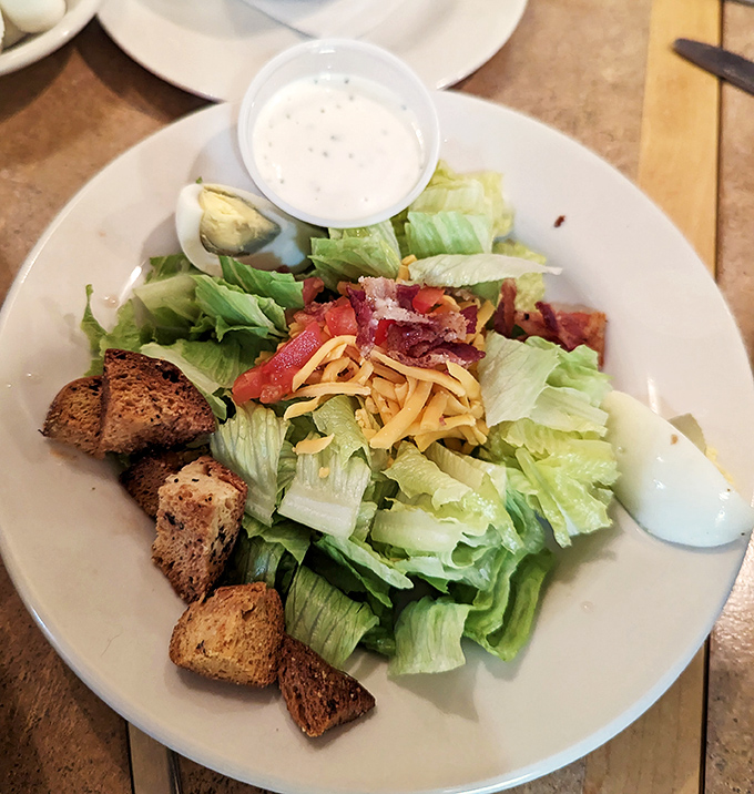 This isn't just a side salad&mdash;it's the supporting actor that steals the scene with crisp lettuce, sharp cheddar, and croutons that crunch like autumn leaves.