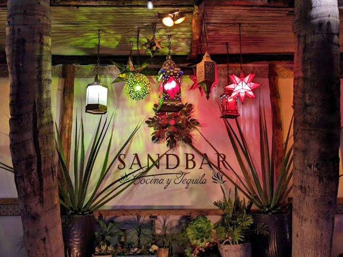 Evening transforms Sandbar into a magical grotto of twinkling lights. Those hanging lanterns aren't just pretty—they're strategic mood enhancers for your dining experience.
