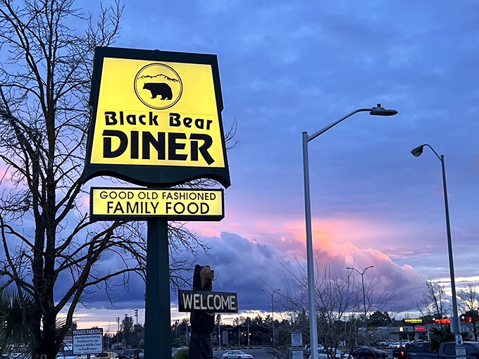 That yellow sign against the twilight sky works like a tractor beam for empty stomachs, drawing in hungry travelers from miles around.