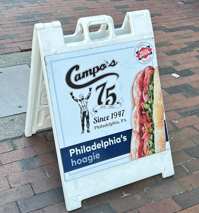 Seventy-five years of sandwich mastery advertised on a humble sidewalk sign&mdash;if only brick streets could talk about the cheesesteaks they've witnessed.