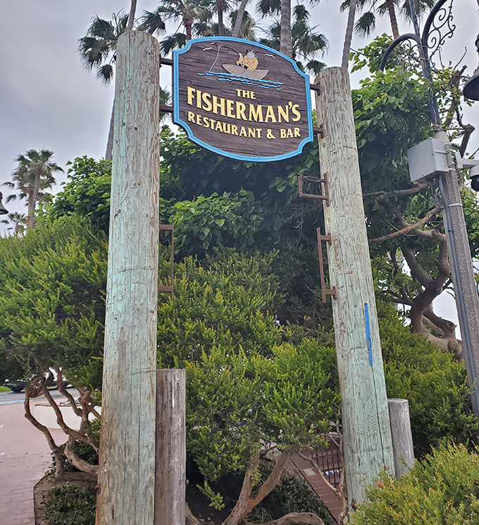 The weathered sign posts stand like sentinels, guiding hungry pilgrims toward seafood salvation with coastal charm to spare.