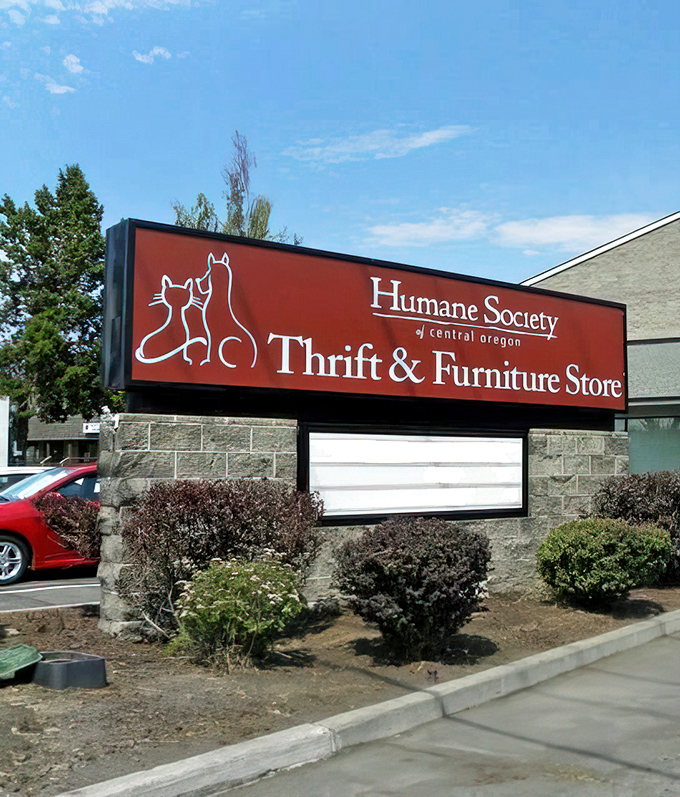 The bold red sign announces the store's dual purpose. Every purchase helps fund the Humane Society of Central Oregon's important work.