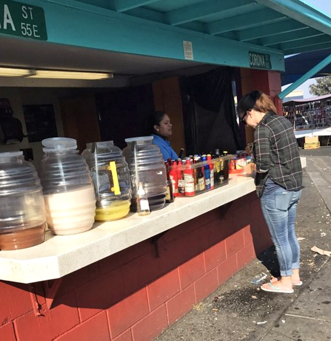 Homemade aguas frescas and condiments line this snack counter. Each jar contains summer refreshment that Starbucks can't bottle at any price.