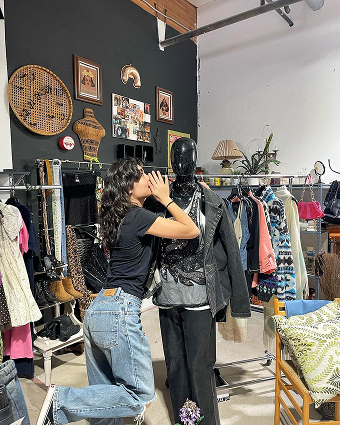 The careful curation continues as staff thoughtfully arrange merchandise, ensuring each vintage piece finds its perfect showcase.