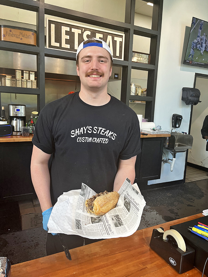 Behind every great cheesesteak is someone who takes pride in their craft&mdash;this smile says "I'm about to make your day significantly better."