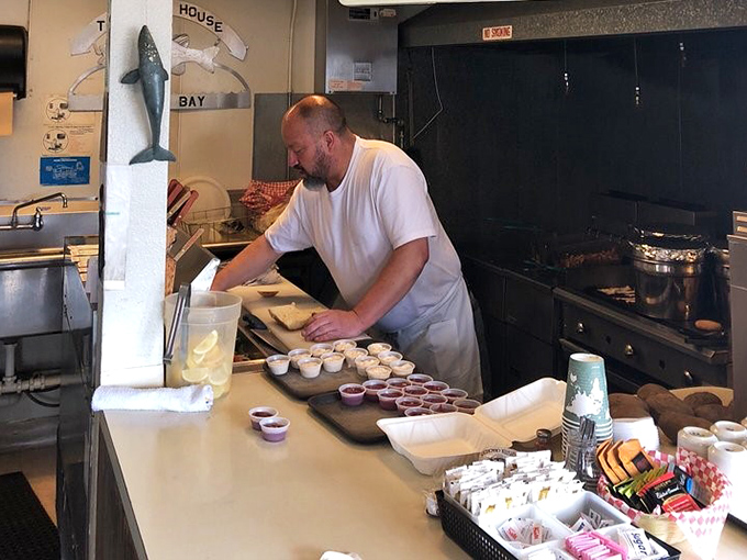 The real magic happens behind the scenes, where skilled hands transform today's catch into tonight's dinner with practiced efficiency.