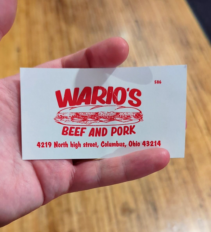 The business card reveals a second location on North High Street—proof that great sandwich artistry deserves to spread throughout Columbus.
