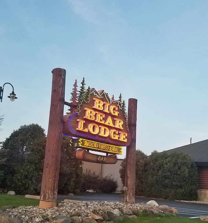 The neon sign stands like a beacon for hungry travelers, promising wood-fired delights within this rustic retreat.