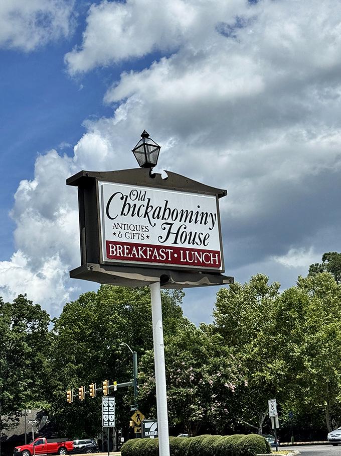 The sign stands tall against cloud-dotted skies, a beacon for hungry travelers seeking refuge from chain restaurant mediocrity.