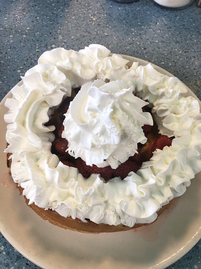 This strawberry waffle topped with whipped cream is basically dessert disguised as breakfast - genius move.