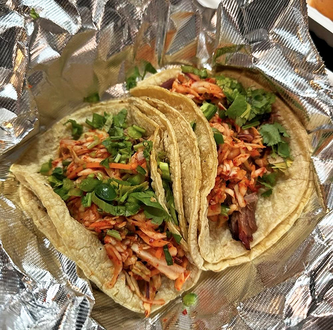Tacos that bridge continents: smoked meat, kimchi slaw, and fresh cilantro create a handheld United Nations of flavor. Diplomacy never tasted so good.
