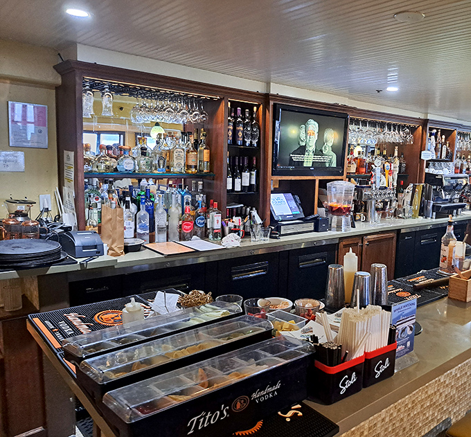 A bar stocked for serious maritime drinking. Those bottles aren't just alcohol&mdash;they're liquid courage for when the check arrives.