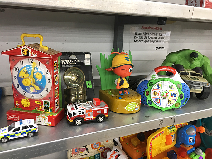 Childhood nostalgia by the shelf-full. That Fisher-Price clock probably taught time to three generations before landing here.