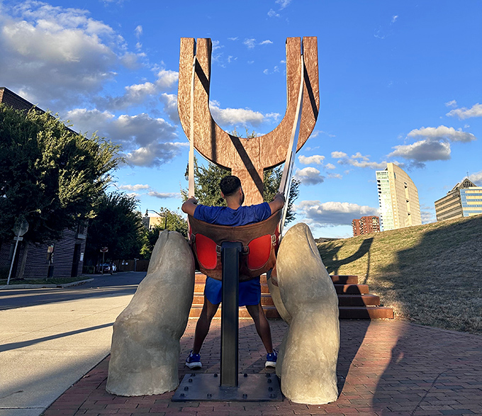 Taking the hot seat! Visitors channel their inner human cannonball while friends capture the moment of pretend propulsion.
