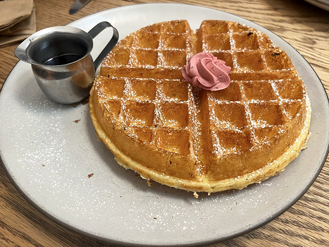 The waffle that launched a thousand food photos. Golden, crisp, and dusted with powdered sugar &ndash; it's wearing that dollop of pink butter like a tiny, delicious corsage.