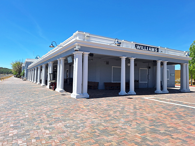 The historic Williams Depot stands as a gleaming white sentinel of railroad history, its columned facade welcoming modern adventurers.
