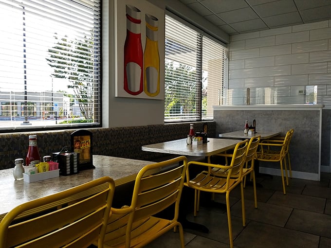Cheerful yellow chairs brighten this corner spot, while condiments stand ready for whatever deliciousness comes your way.