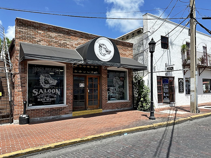 The brick facade and famous hog sign mark the entrance to Key West's beloved dive where island stories are born.