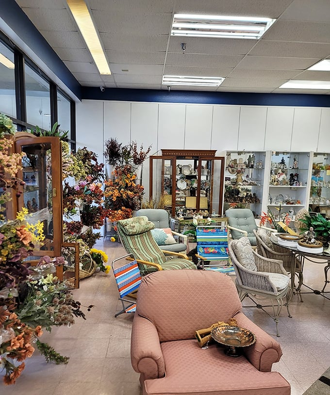 Cozy resale store interior filled with vintage furniture, decorative items, and floral arrangements, offering a charming shopping experience.
