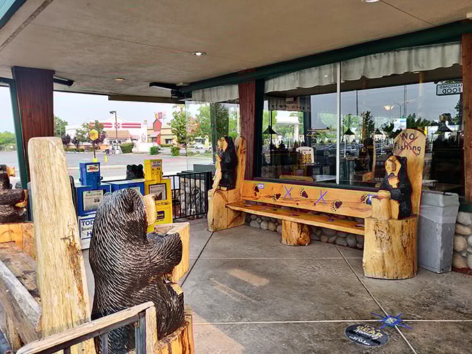 Even the entrance says "wilderness comfort"—where carved wooden bears stand guard, silently judging your decision to order that third side of bacon.