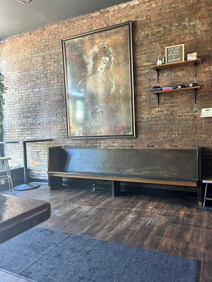 Exposed brick walls and thoughtful art create an atmosphere that says, "Yes, we take sandwiches seriously enough to give them a proper backdrop."