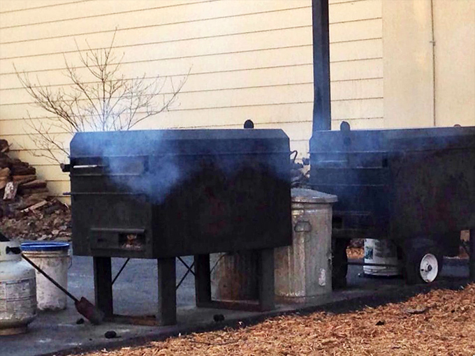 The source of the magic: smokers puffing away like industrial-age dragons, transforming ordinary cuts into extraordinary barbecue through time and temperature.