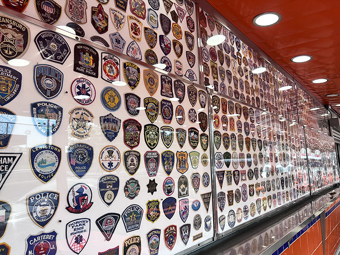 The wall of badges showcases Geno's connection to first responders and law enforcement – a colorful mosaic of community support.