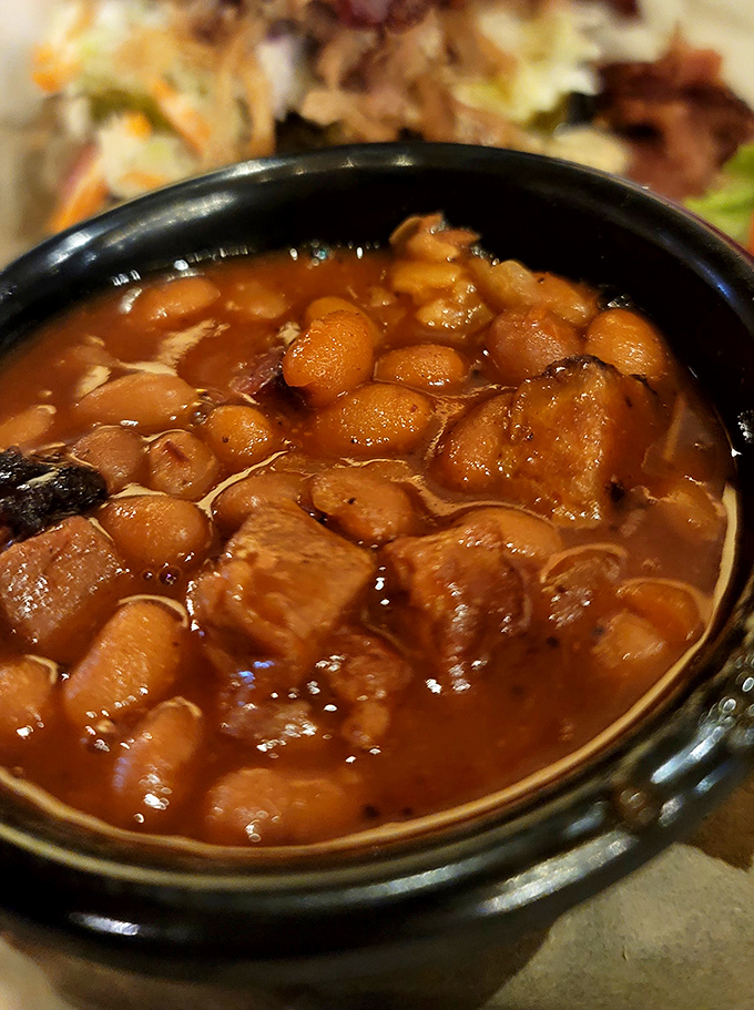 Baked beans that have clearly been hanging out with brisket all day. Each spoonful tells a story of slow-cooked perfection.
