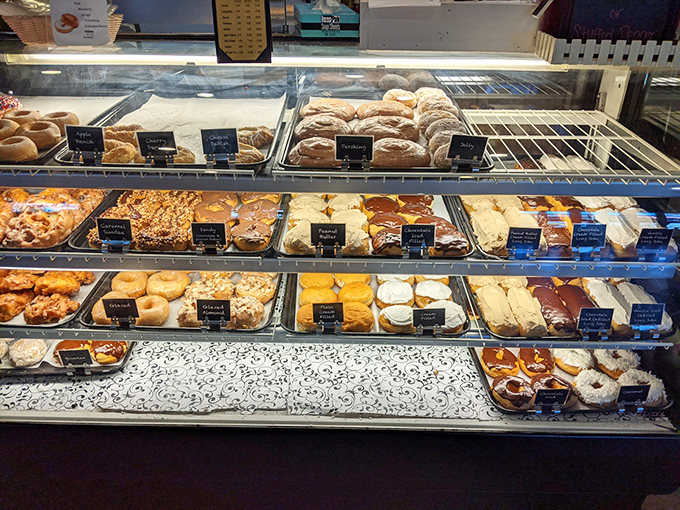 The bakery case—where dreams come in rows, labeled with little black signs, and self-control goes to die a happy death.