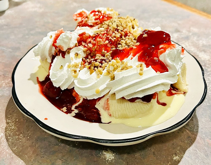 Ice cream, whipped cream, strawberry topping, and nuts create a dessert that's not just eaten but experienced&mdash;a carnival of sweetness on a single plate.
