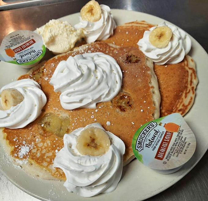 Banana pancakes topped with whipped cream swirls&mdash;breakfast masquerading as dessert in a disguise so thin it's practically transparent, yet we all agree to the charade.