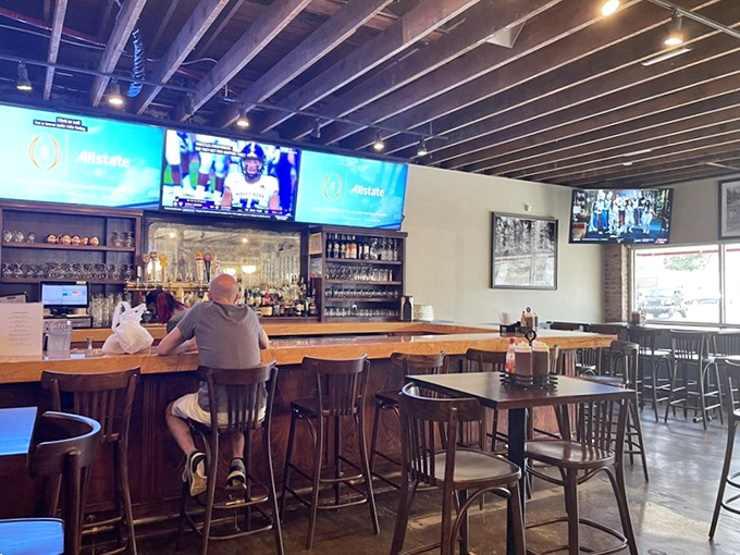 The bar area offers a front-row seat to Tennessee sports and craft brews, proving that good barbecue deserves equally thoughtful beverage companions.