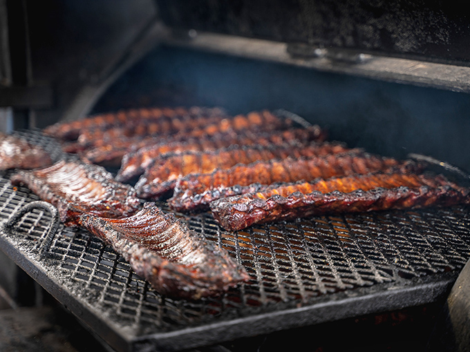 The moment of transformation: when humble meat becomes transcendent barbecue. That smoke isn't just cooking&mdash;it's performing alchemy.